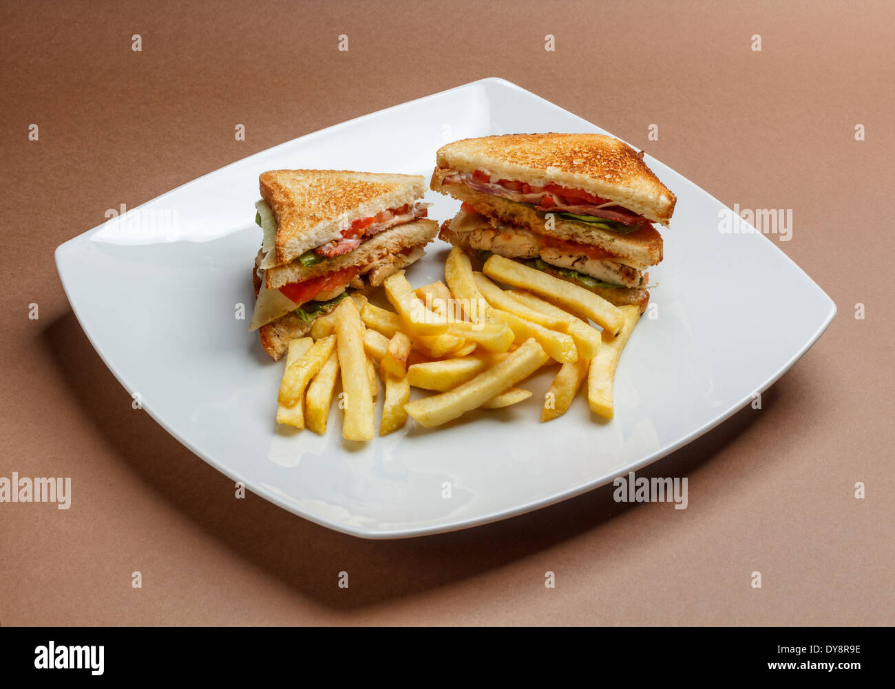 Club sandwich with spicy french fries Stock Photo - Alamy