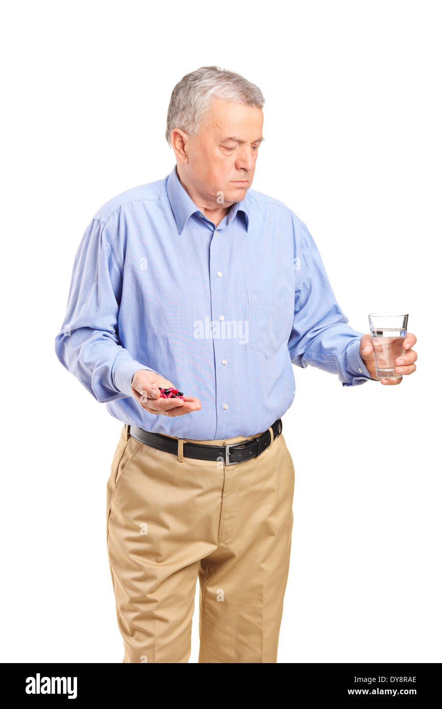 Mature man taking his medications Stock Photo - Alamy