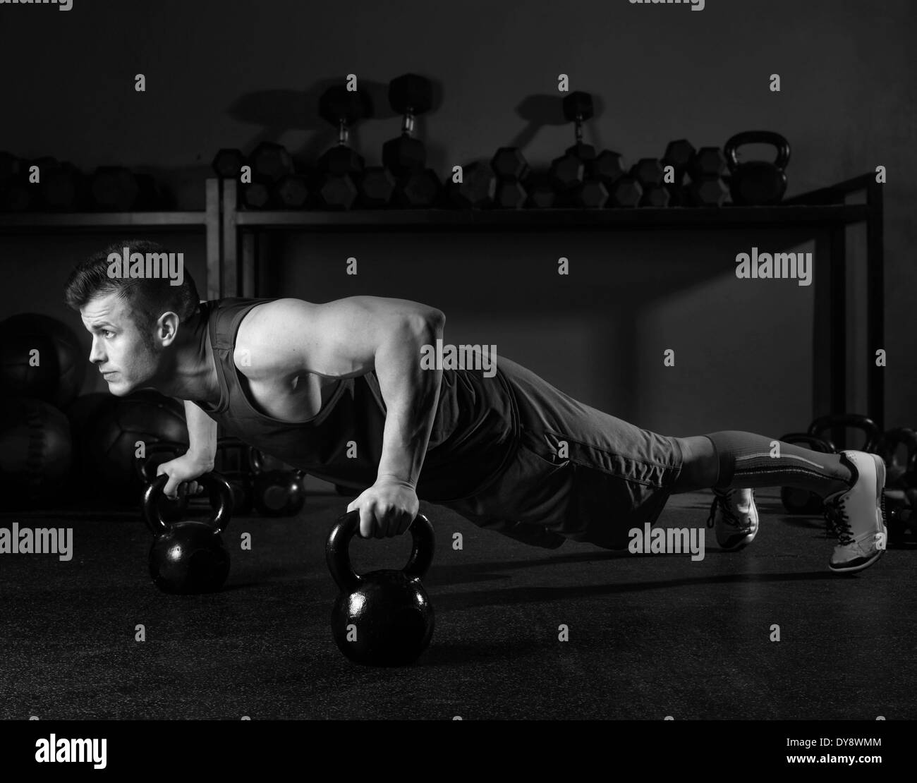 Kettlebells push-up man strength pushup exercise workout at gym Stock ...