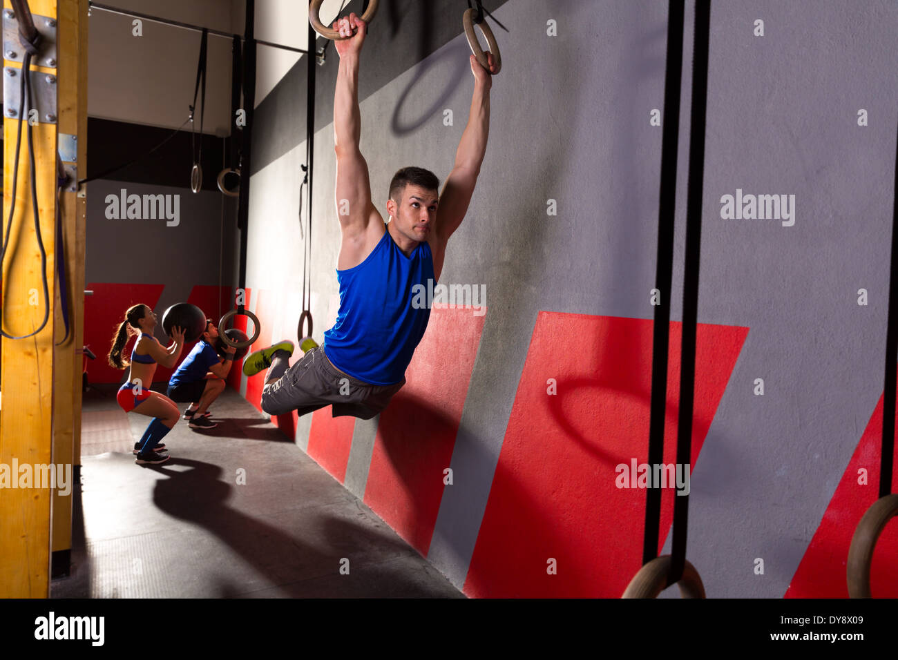 Muscle ups rings man swinging workout exercise at gym Stock Photo - Alamy