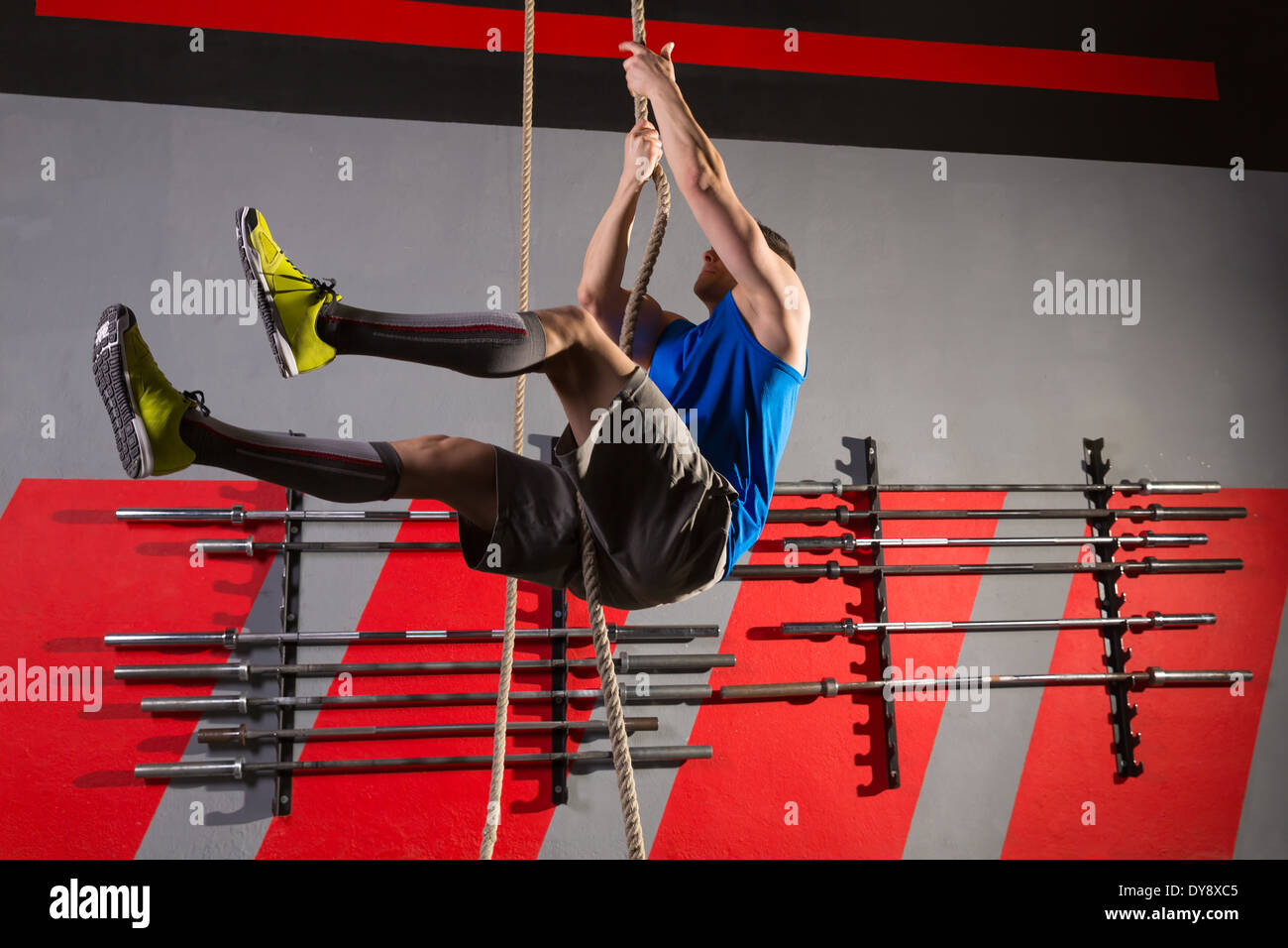 Rope Climb exercise man workout at gym climbing Stock Photo - Alamy