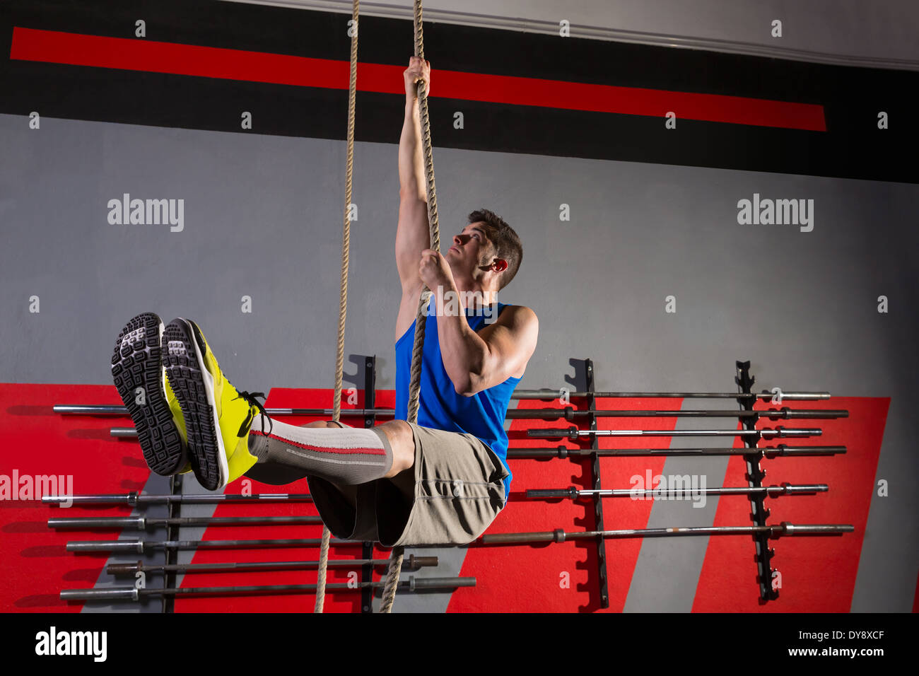Rope Climb exercise man workout at gym climbing Stock Photo - Alamy