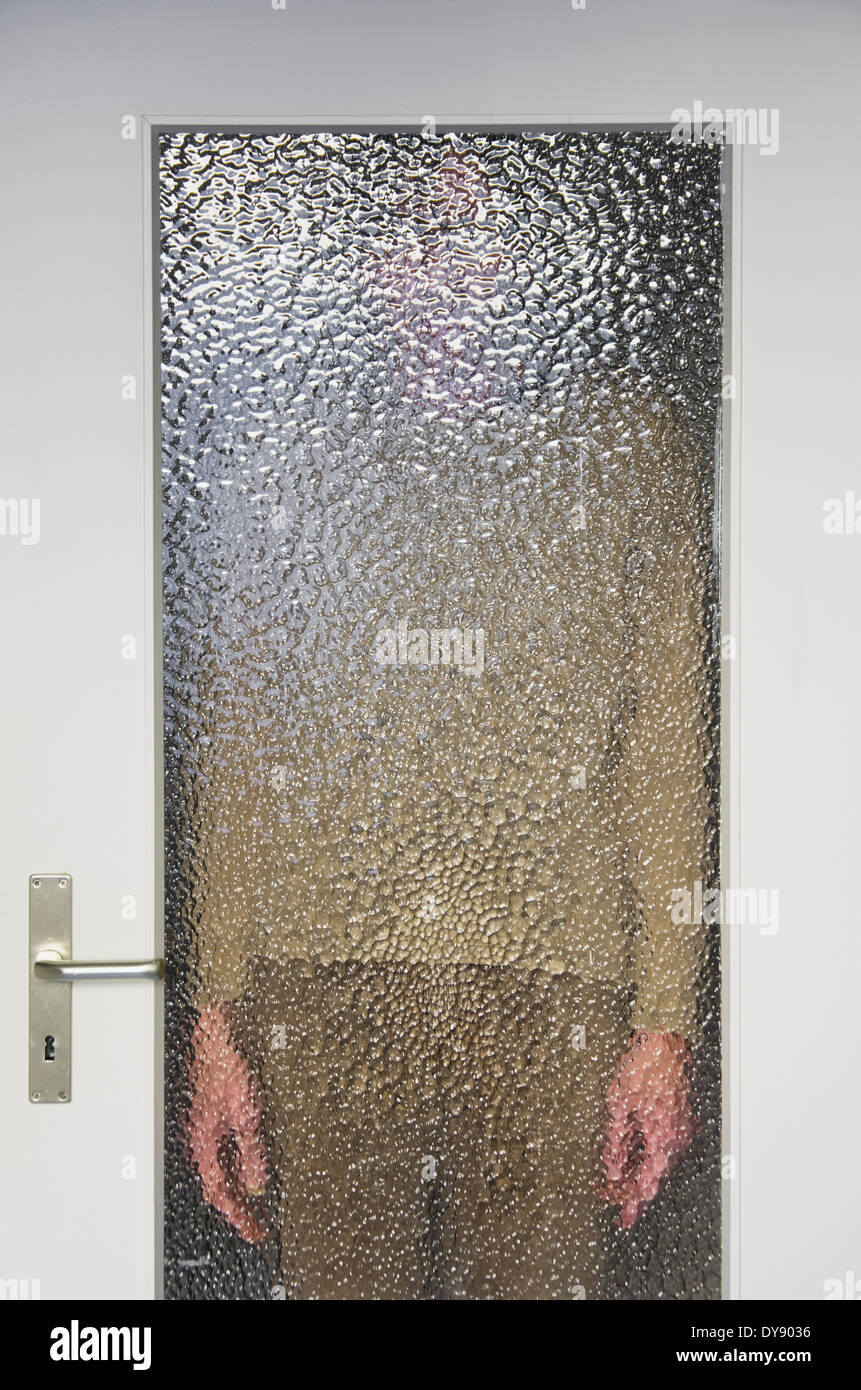 Man standing behind closed door hi-res stock photography and images - Alamy