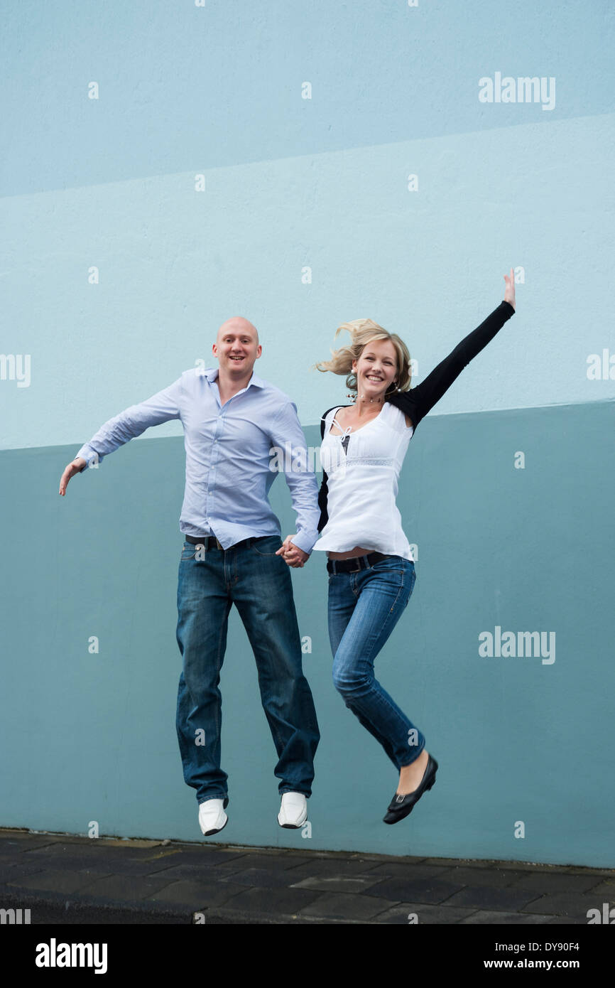 Young couple jumping in the air Stock Photo - Alamy