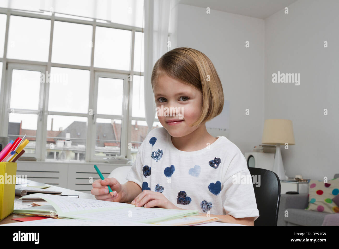 Portrait of girl at desk drawing Stock Photo - Alamy