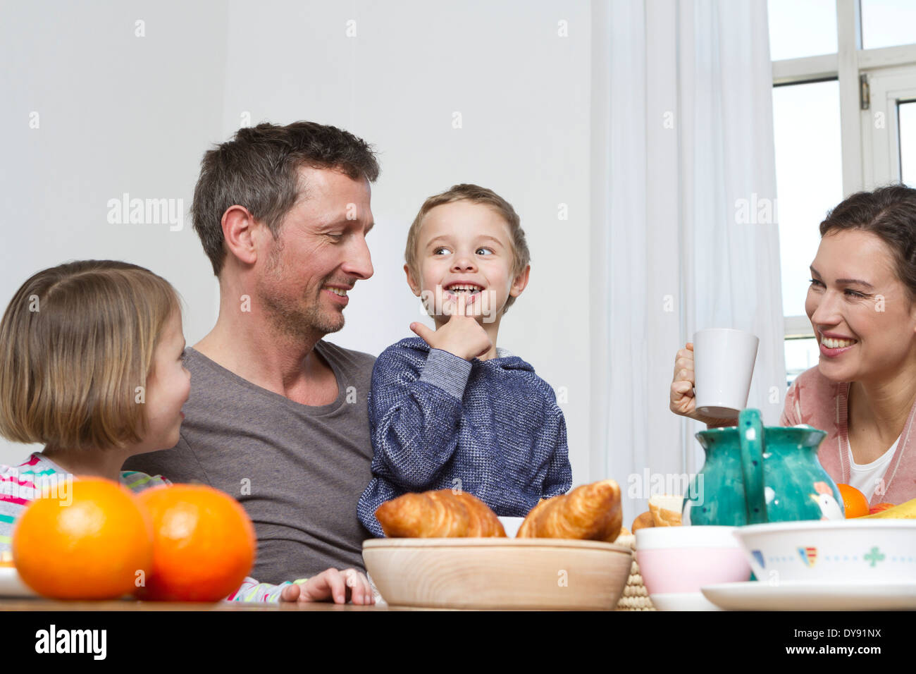 Family of four having healthy breakfast Stock Photo - Alamy