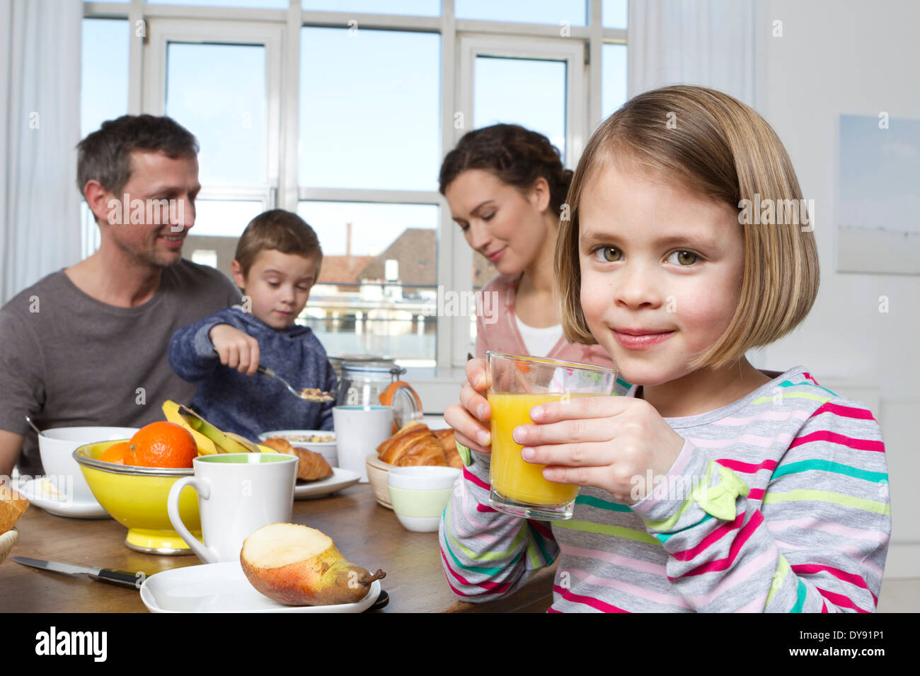 Family of four having healthy breakfast Stock Photo - Alamy