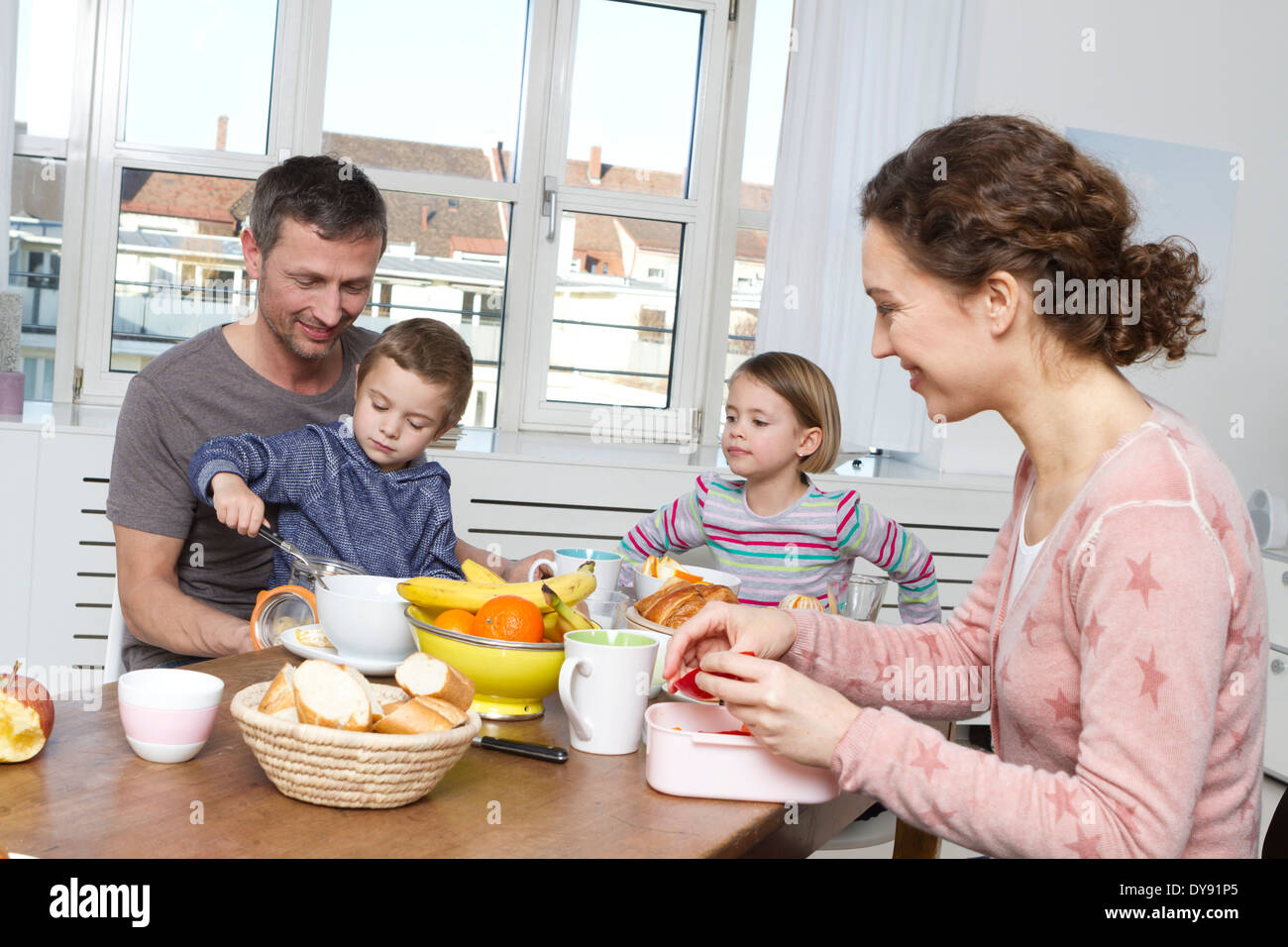 Family of four having healthy breakfast Stock Photo - Alamy