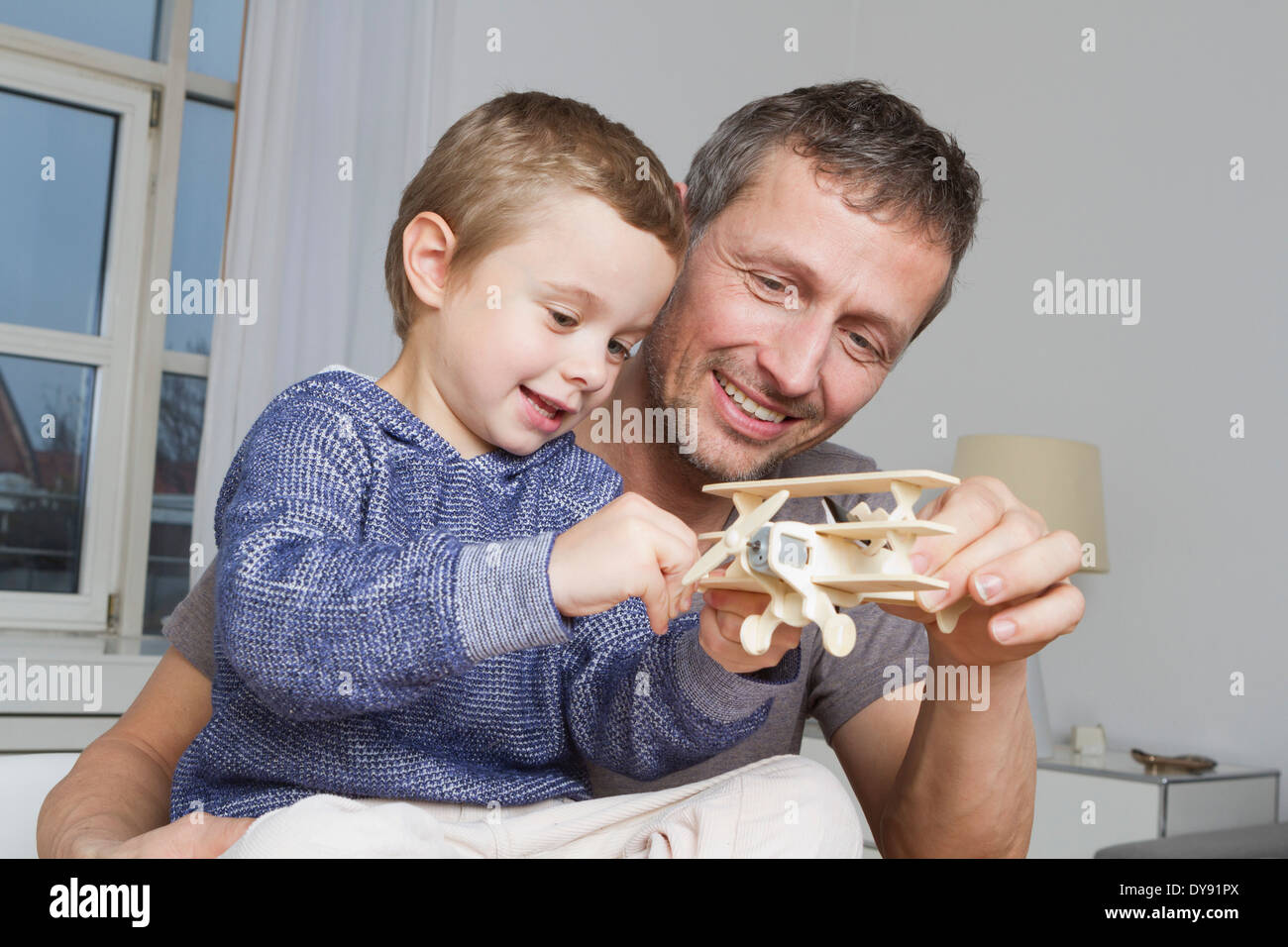 Father and son playing with model airplane Stock Photo - Alamy