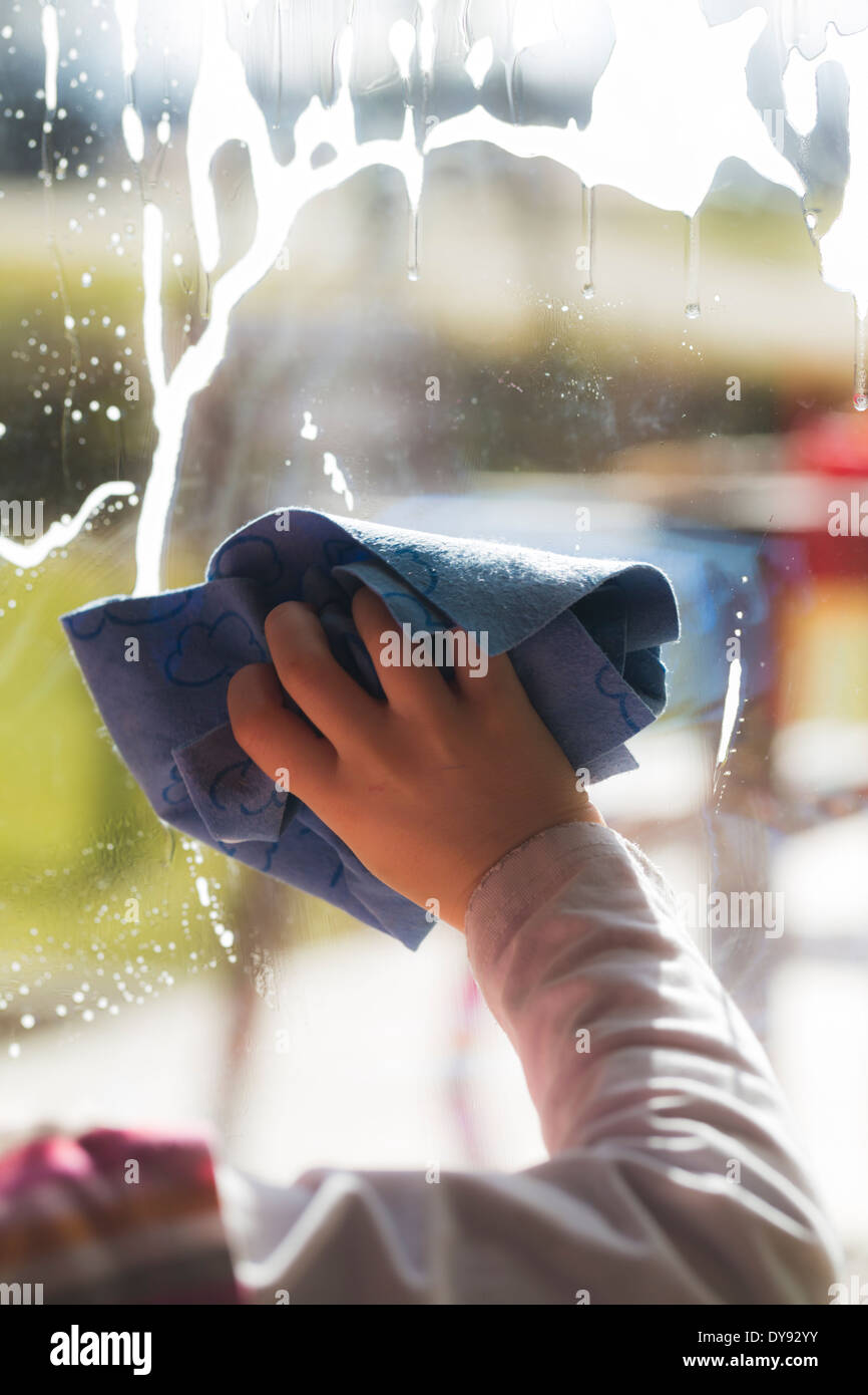 Hand of girl cleaning window Stock Photo - Alamy