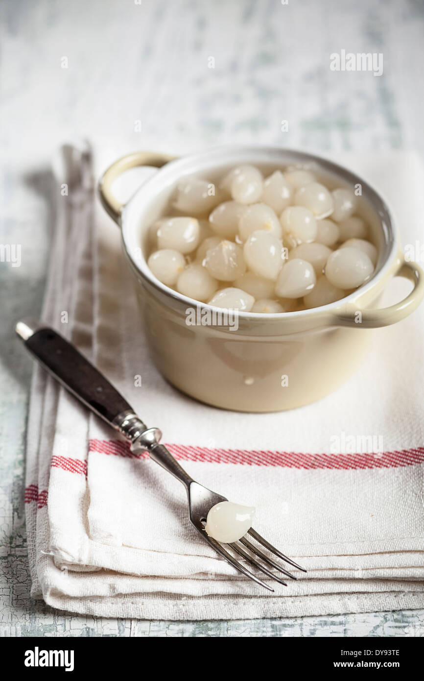 Pickled silverskin onions in a bowl and on fork Stock Photo - Alamy