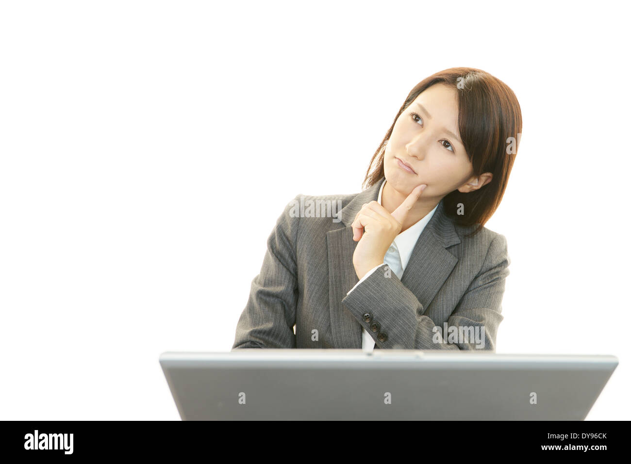 Thinking female office worker Stock Photo - Alamy