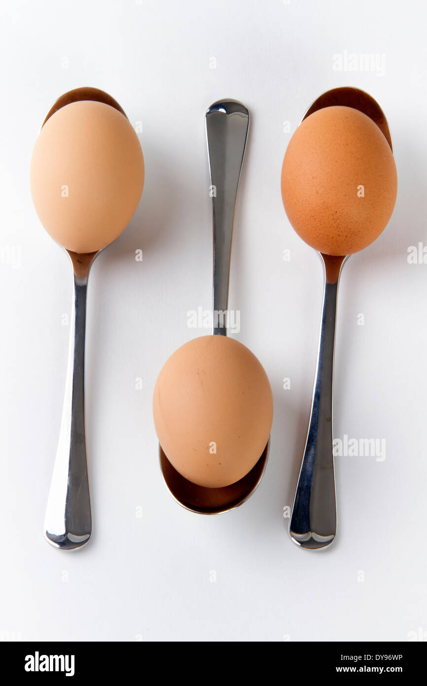Egg and spoon. Three eggs on three spoons Stock Photo - Alamy