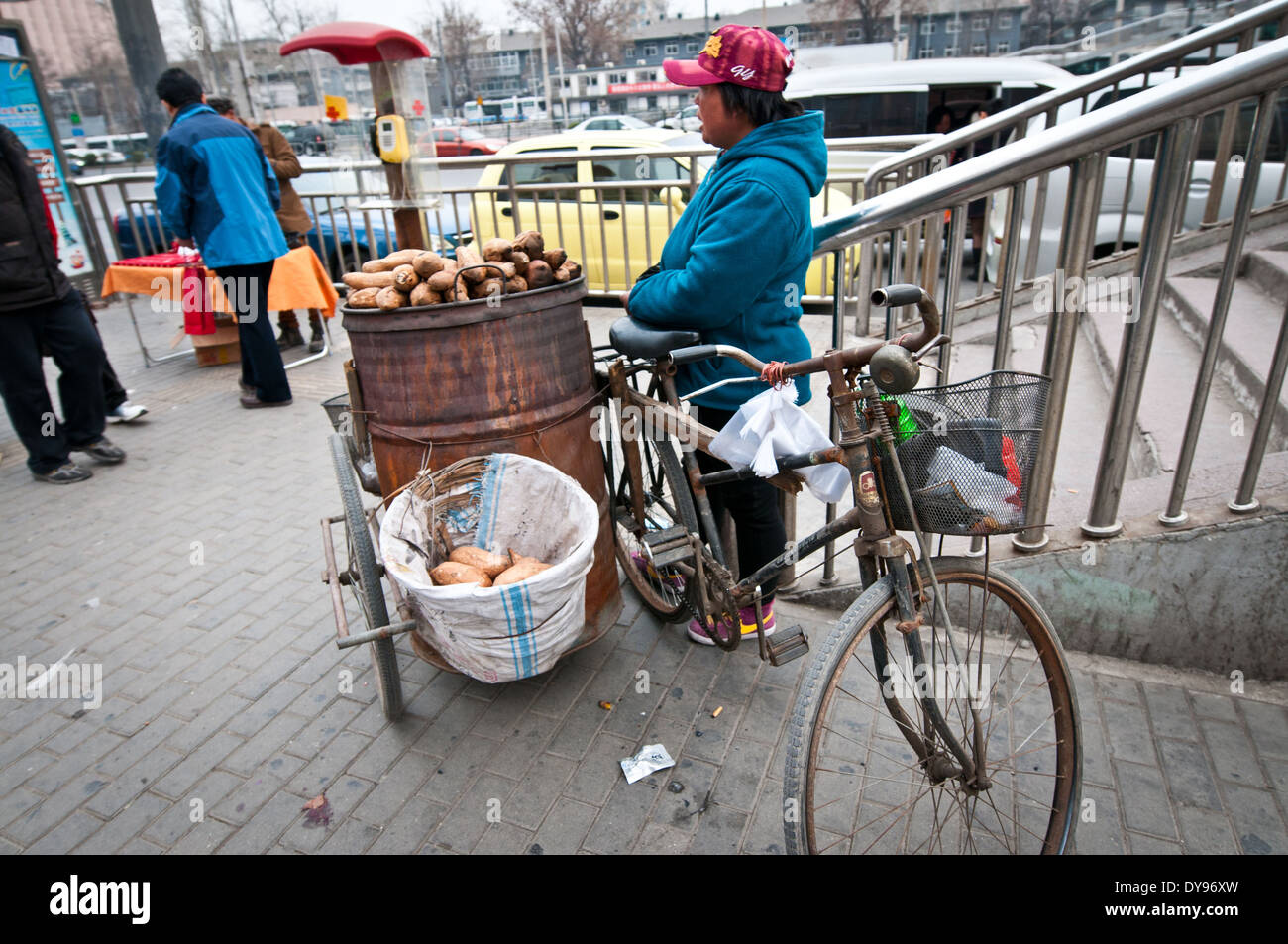 woman selling roasted sweet potatoes on street in Beijing, China Stock ...