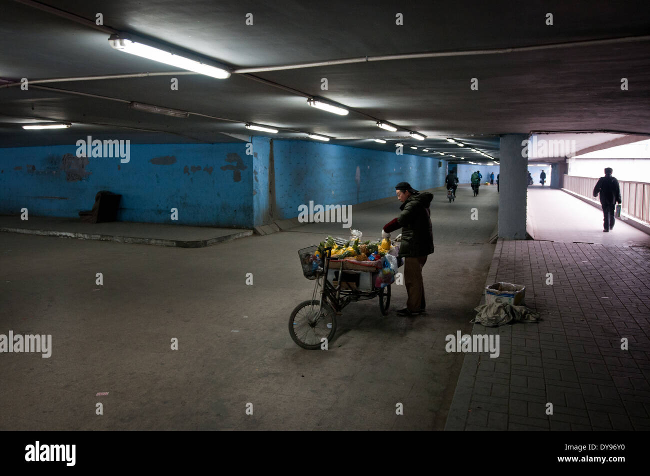 Man selling pineapples in underground passage in Beijing, China Stock ...