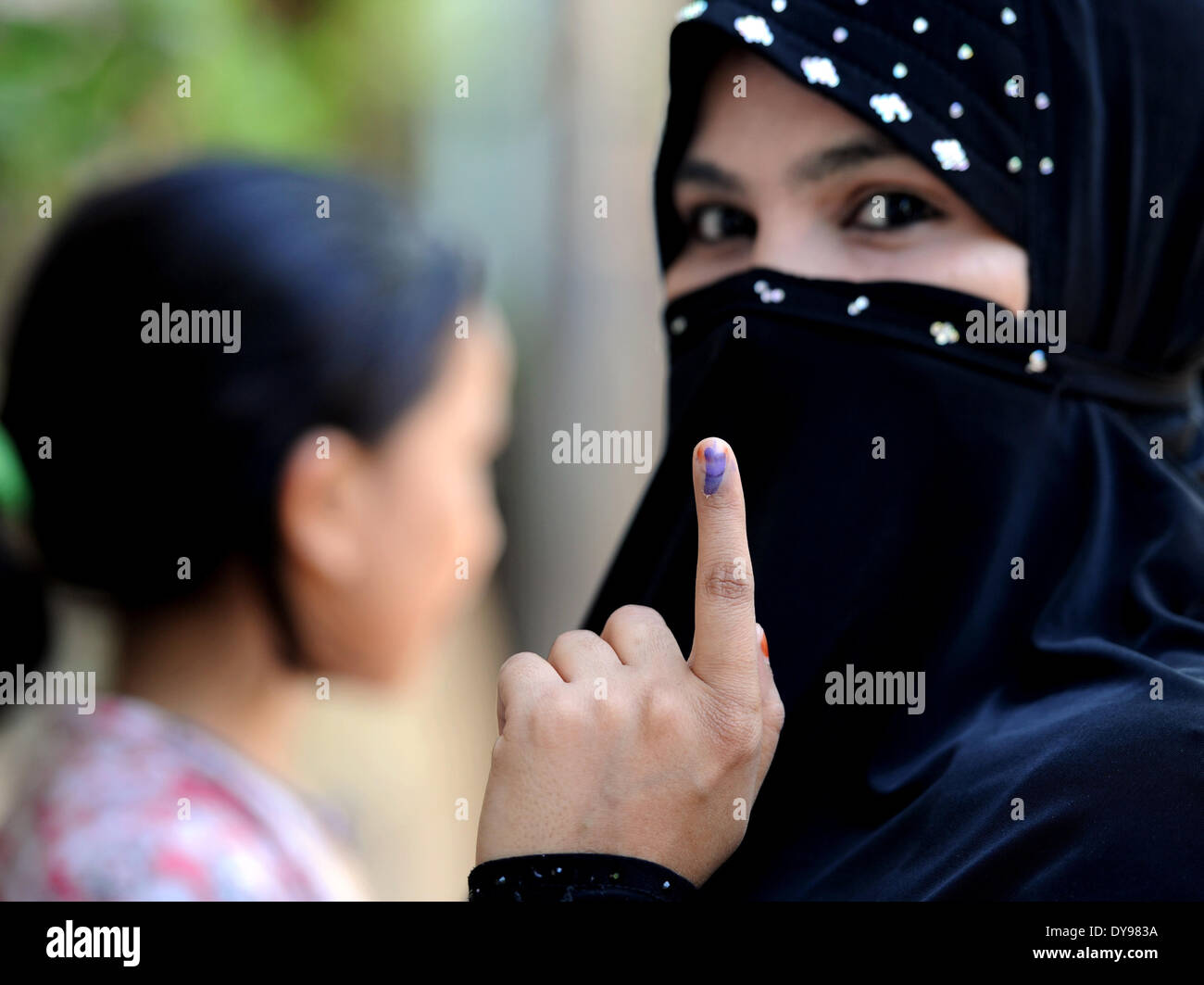 New Delhi, India. 10th Apr, 2014. A muslim woman shows her inked finger ...