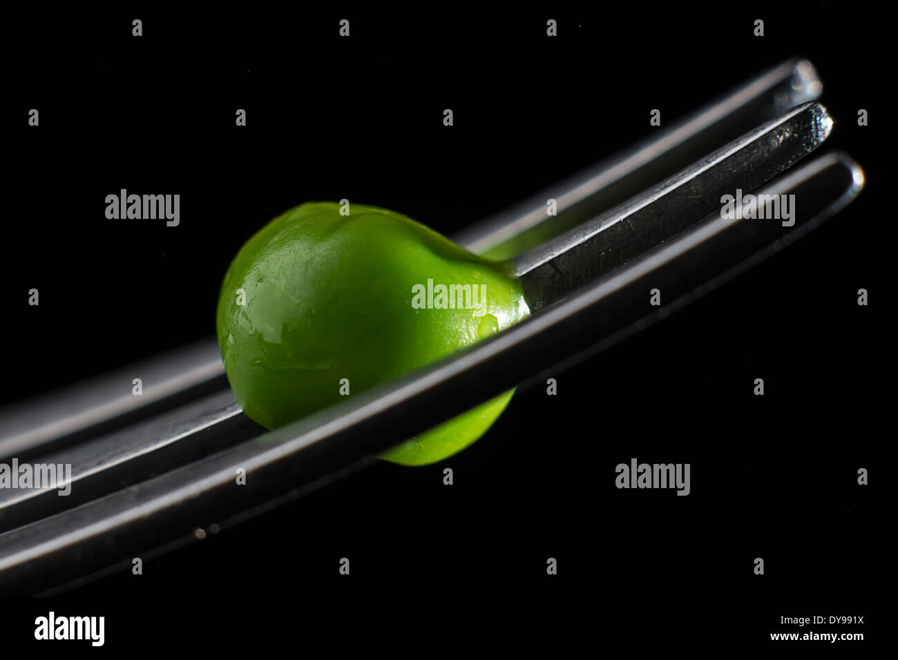 A single pea on a fork. one of your five a day Stock Photo - Alamy