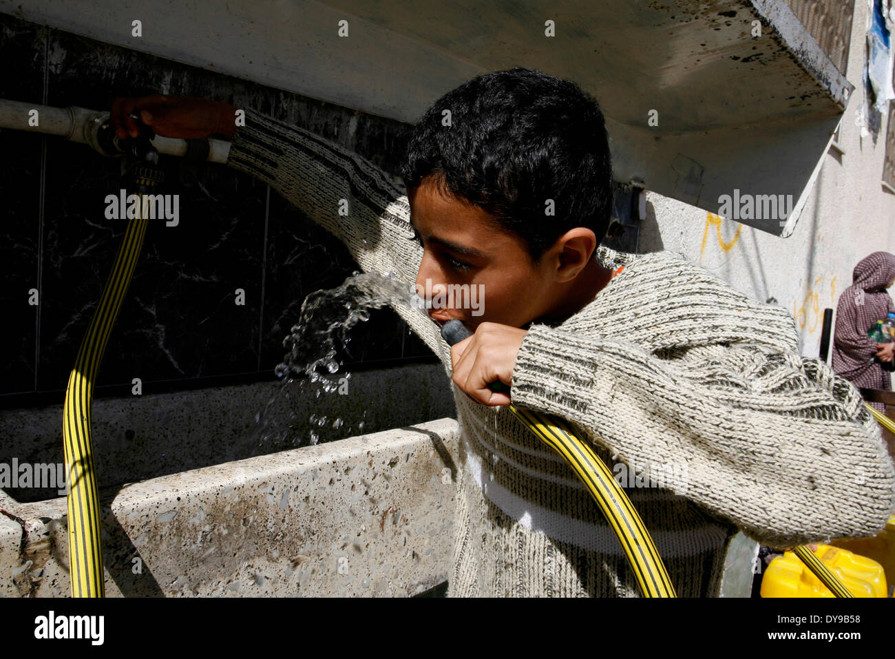 RAFAH, PALESTINE-APRIL 10: A Palestinian boy drinks water from a water ...