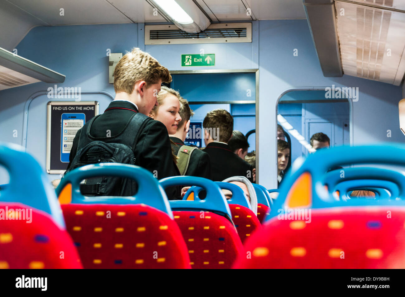 Teenage school children in uniform queuing to get off a train Stock ...