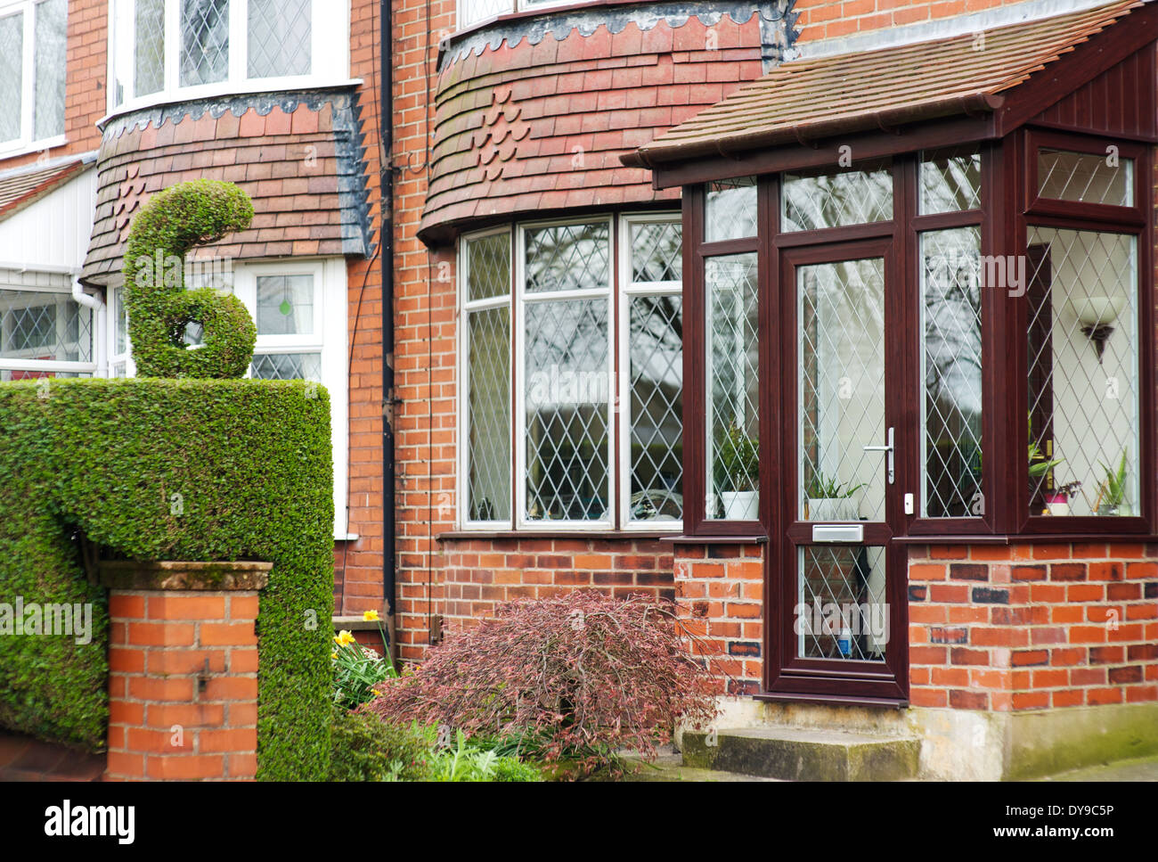 house number carved into hedge Stock Photo - Alamy