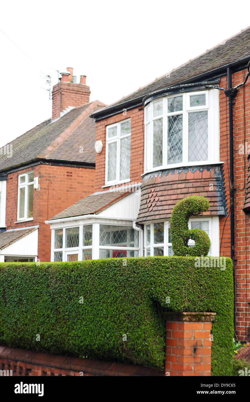 house number carved into hedge Stock Photo - Alamy