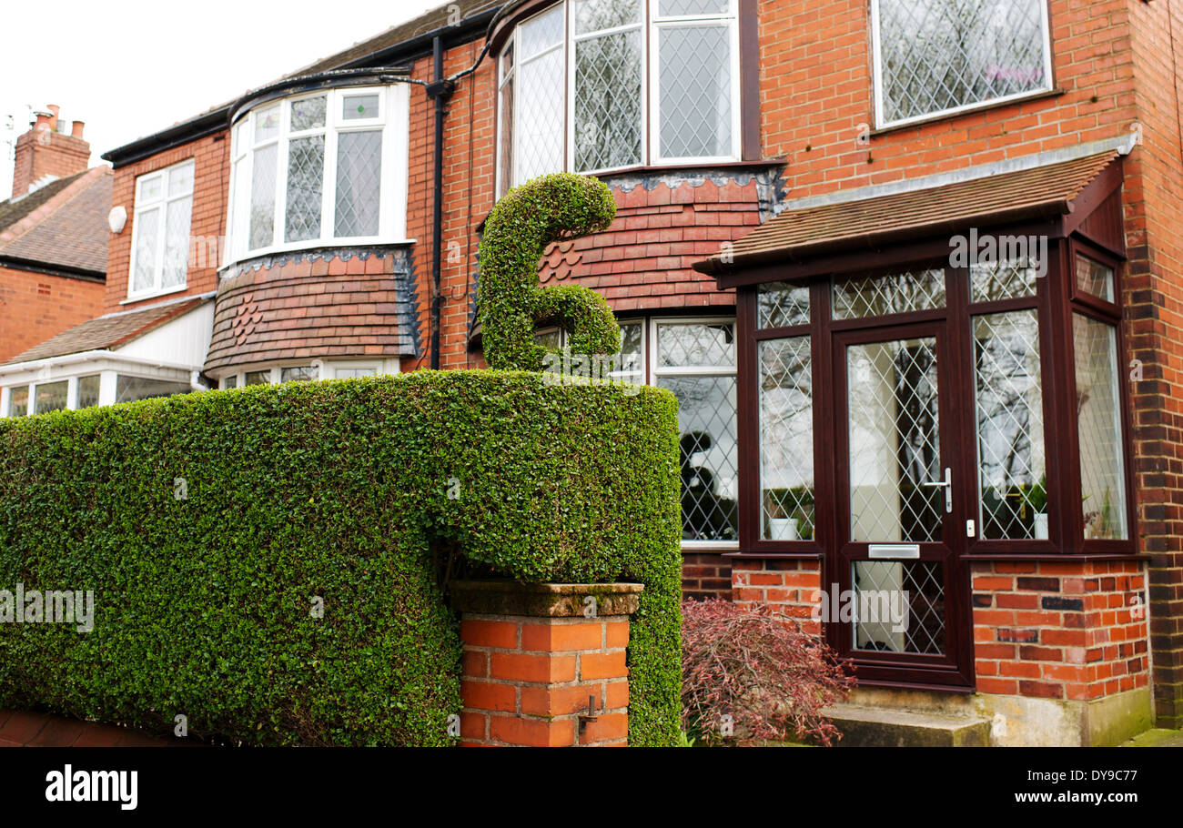 house number carved into hedge Stock Photo - Alamy