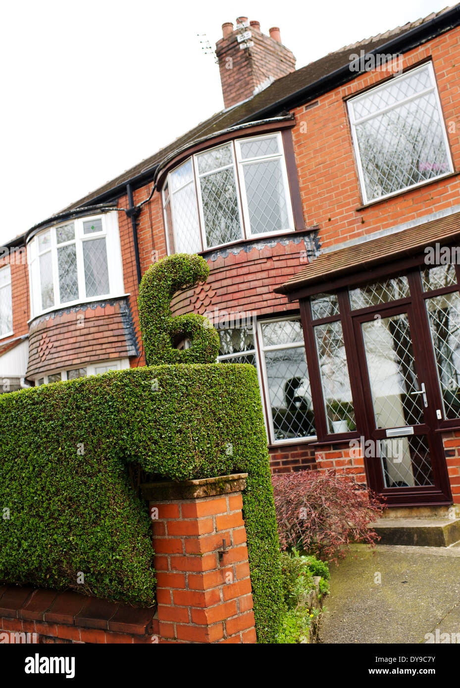 house number carved into hedge Stock Photo - Alamy