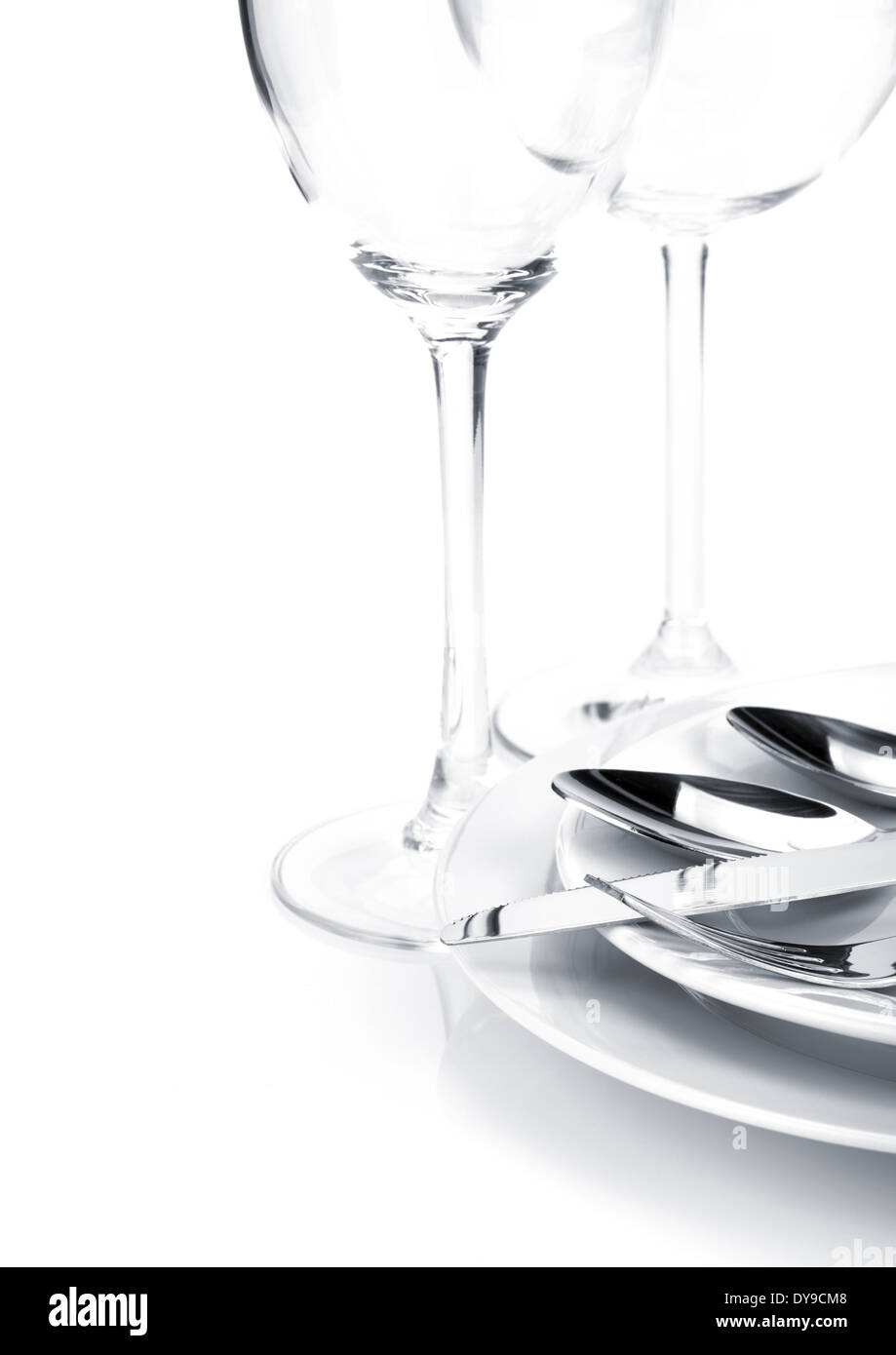 Silverware or flatware set over plates and wine glass. Isolated on ...