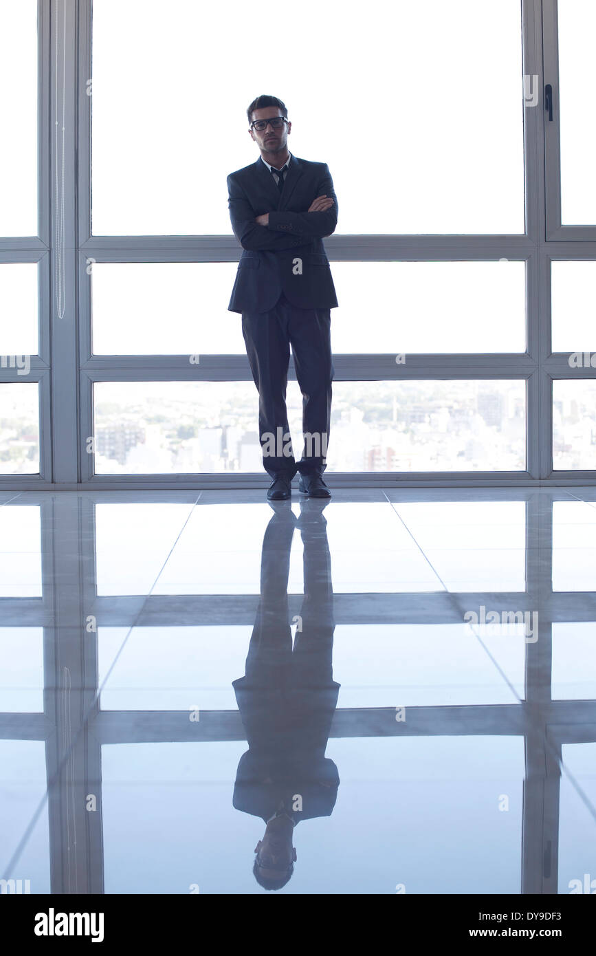Businessman standing window looking distance hi-res stock photography ...