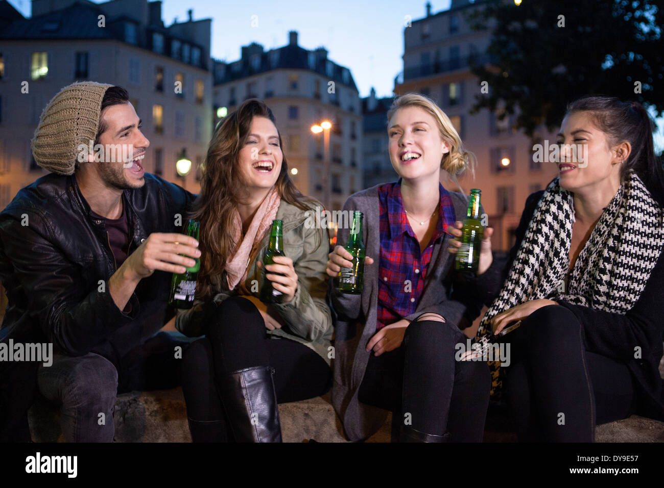 Friends having beers together outdoors Stock Photo - Alamy