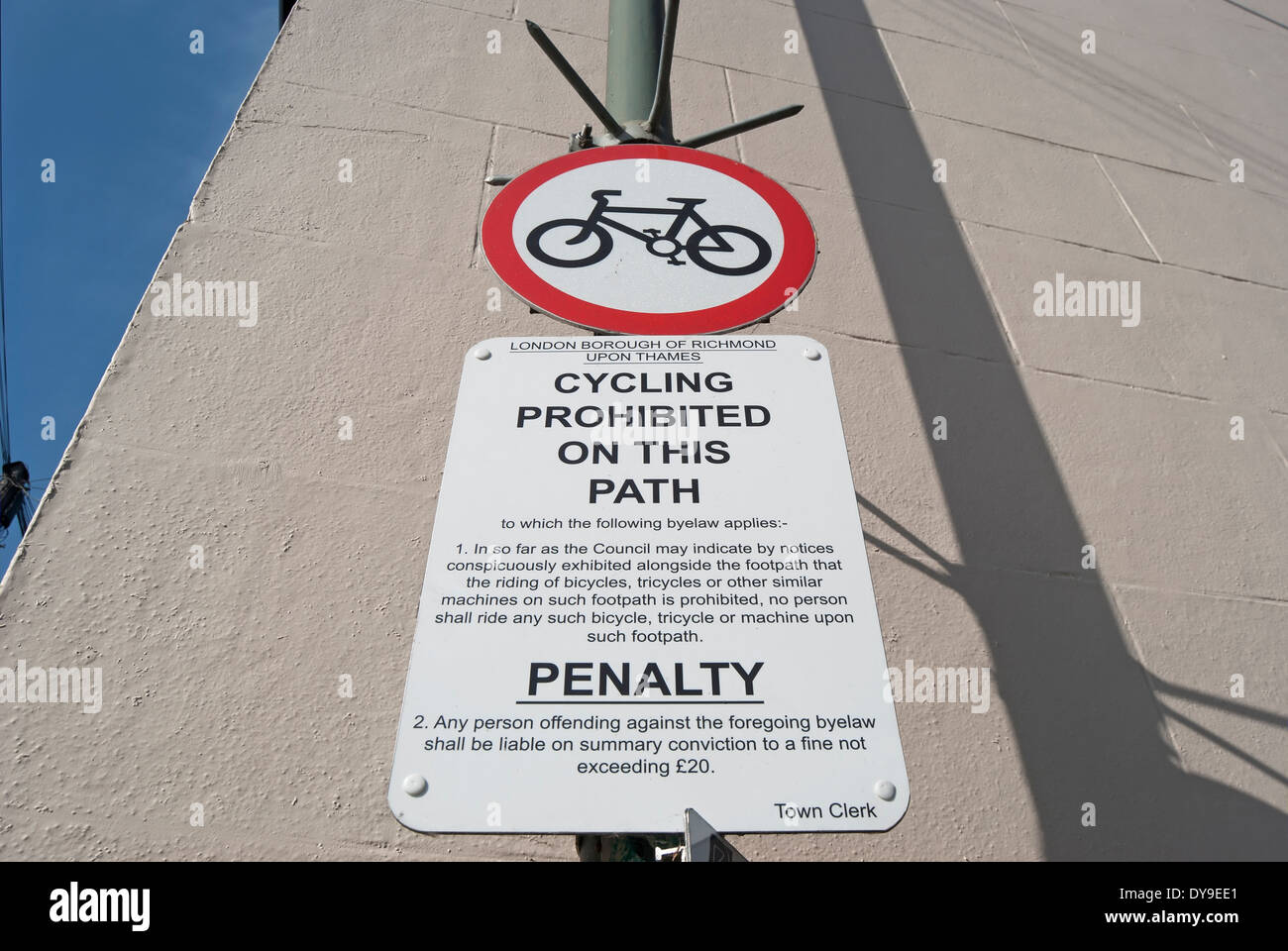no cycling sign above notice warning of penalites for infringement ...