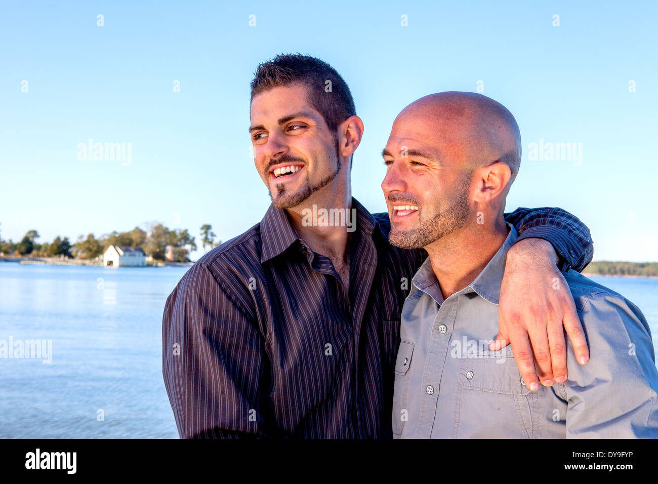 Two gay men, who are husbands or boyfriends, relax and share some ...