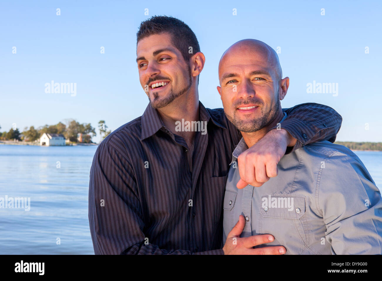 Two gay men, who are husbands or boyfriends, relax and share some ...
