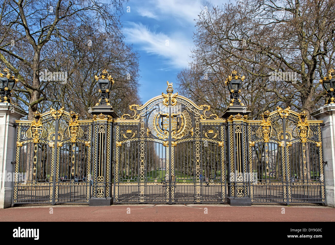 Metal gate of a park decorated with golden ornaments Stock Photo - Alamy