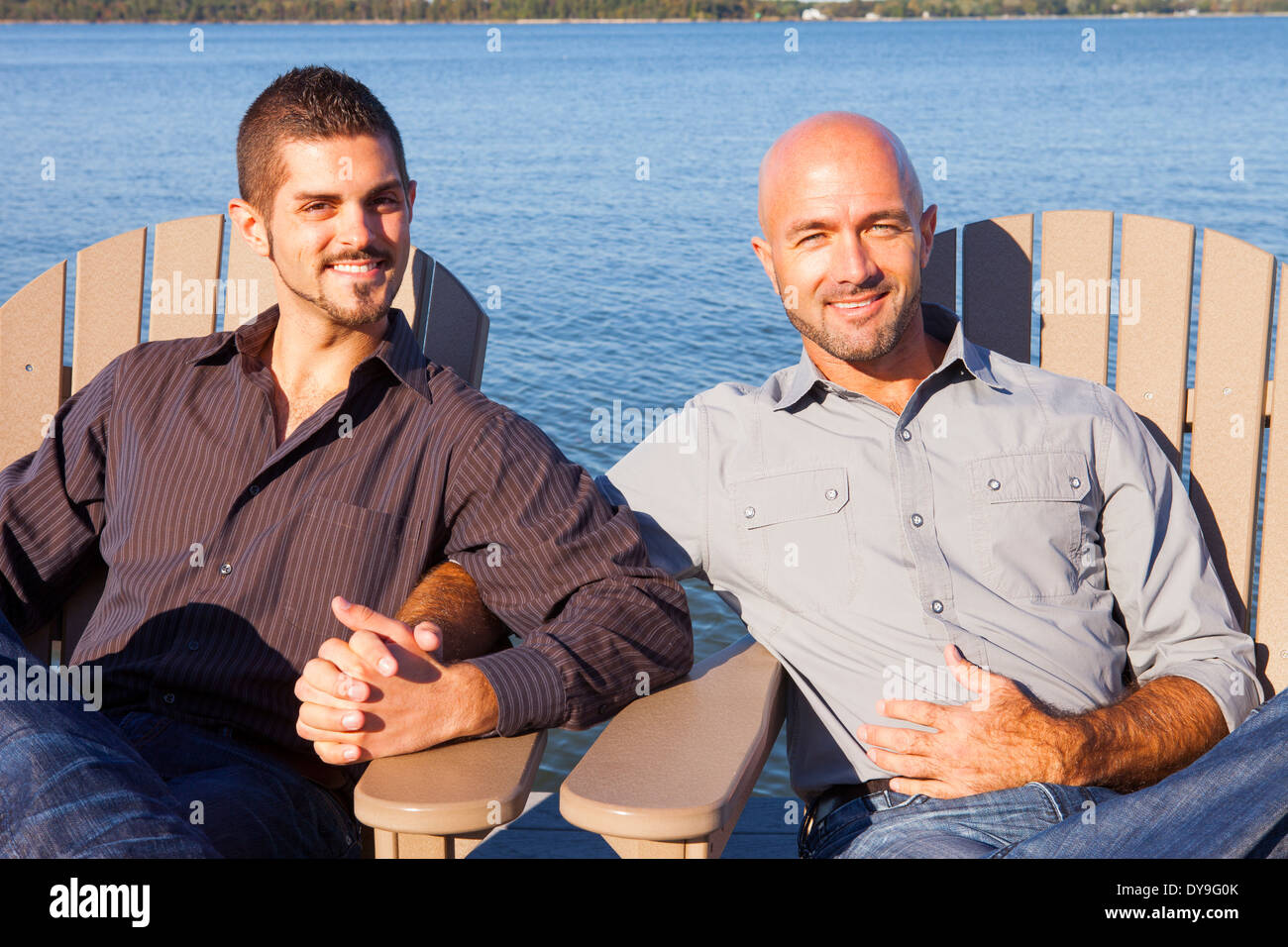 Two gay men, who are husbands or boyfriends, relax and share some ...