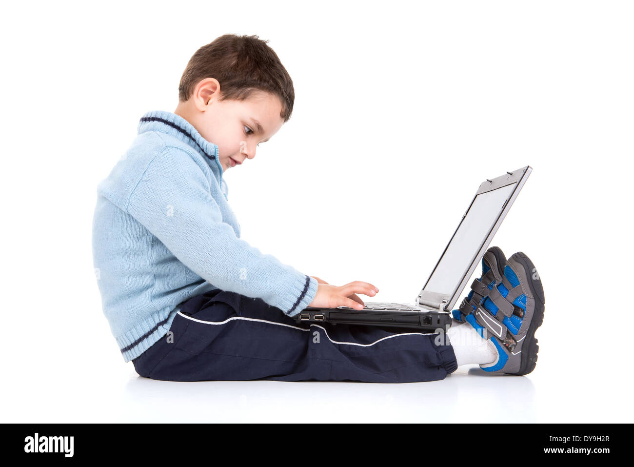Young boy with laptop computer isolated in white Stock Photo - Alamy