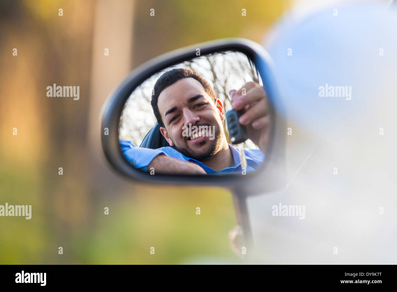 Young black latin american driver holding car keys driving his new car ...