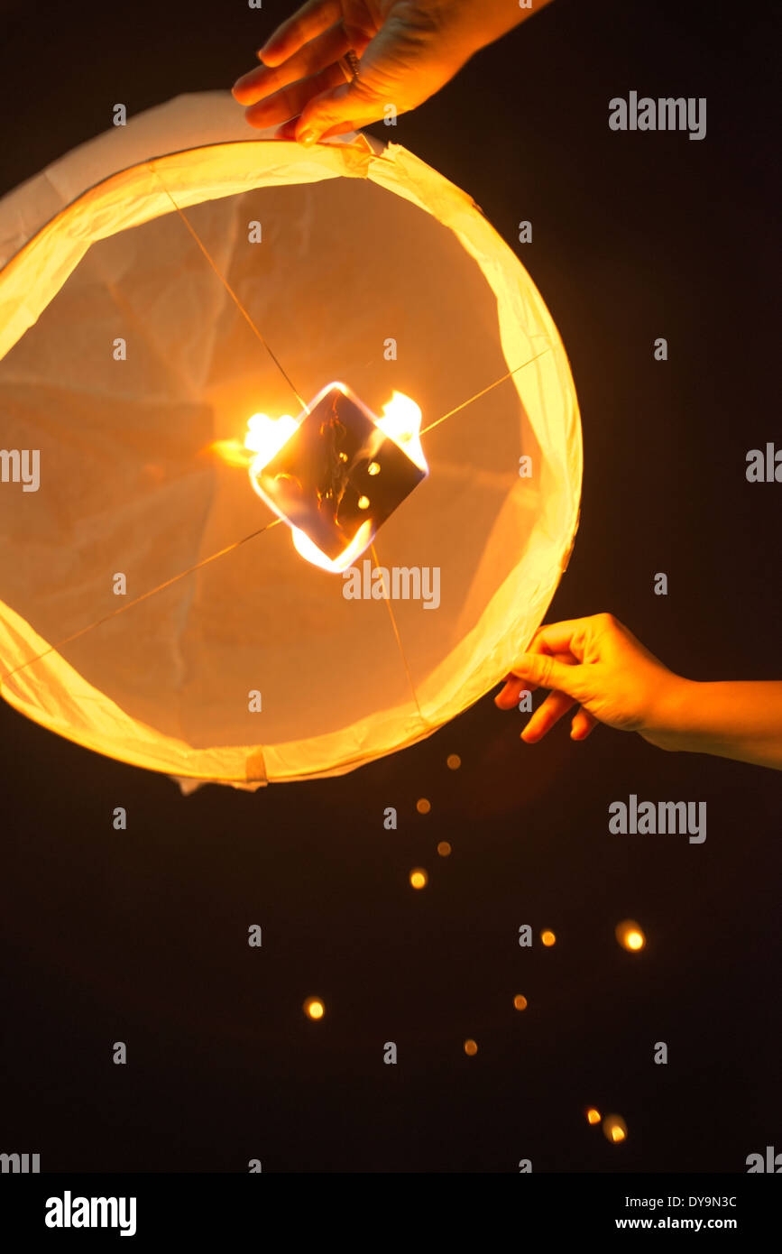 Releasing flying candles, paper balloons with hot air to freely flow ...