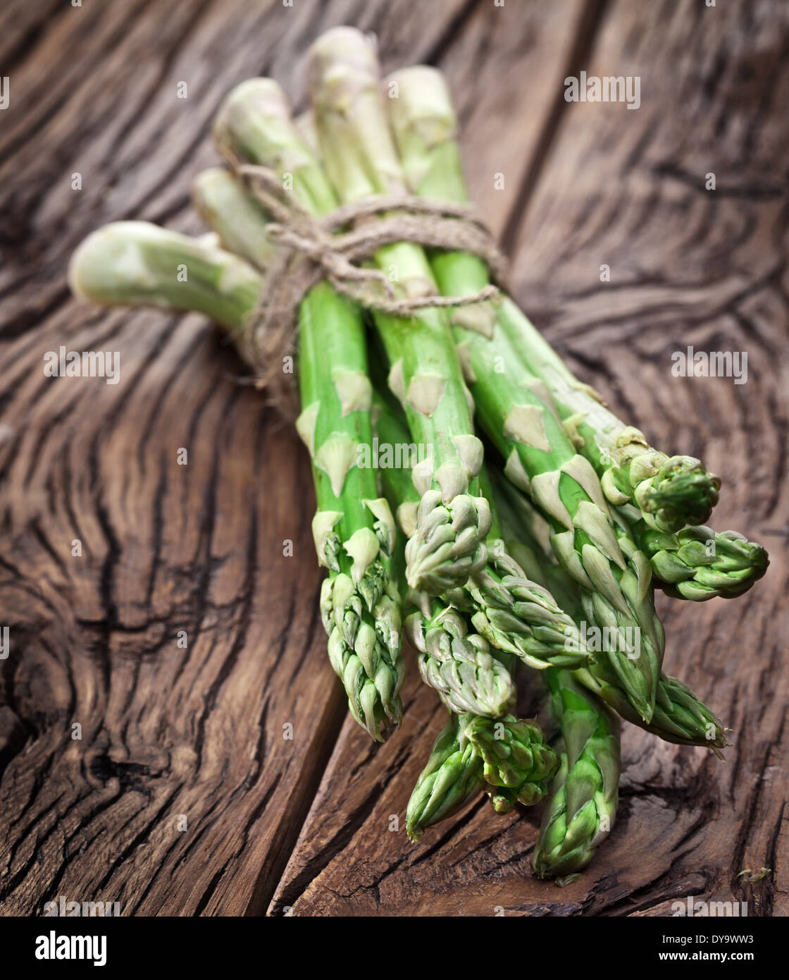 Bunch of asparagus on a wooden table Stock Photo - Alamy