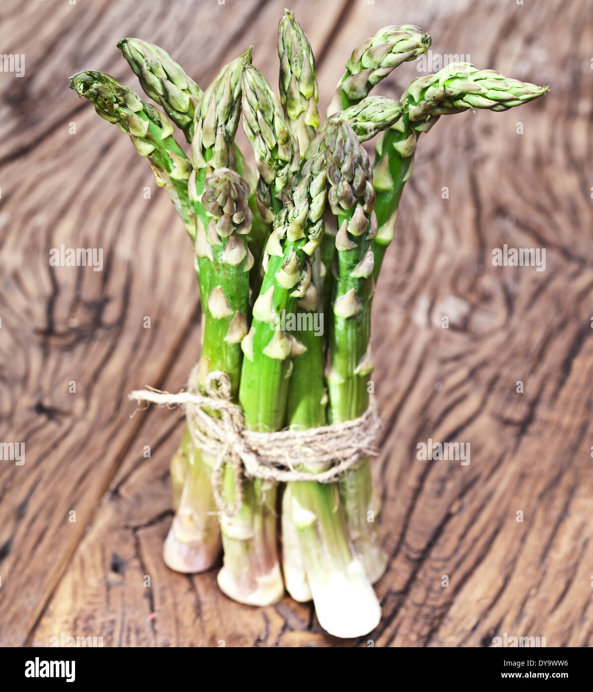Bunch of asparagus on a wooden table Stock Photo - Alamy