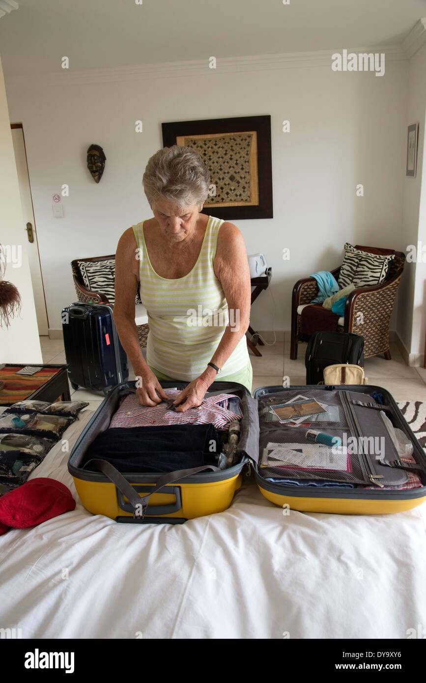 Female holidaymaker packing a suitcase in a hotel bedroom Stock Photo ...