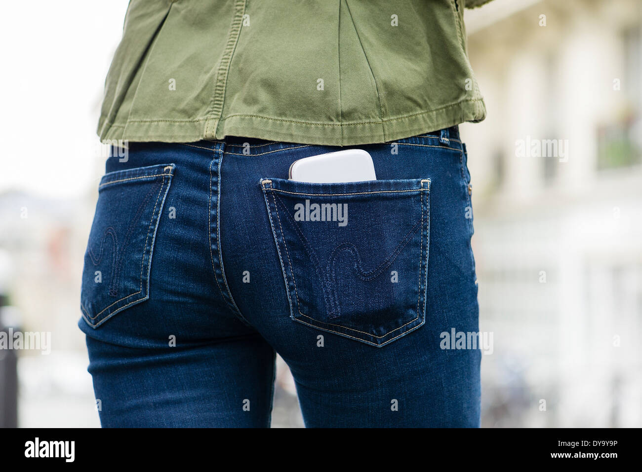 Woman carrying smartphone in back pocket Stock Photo - Alamy