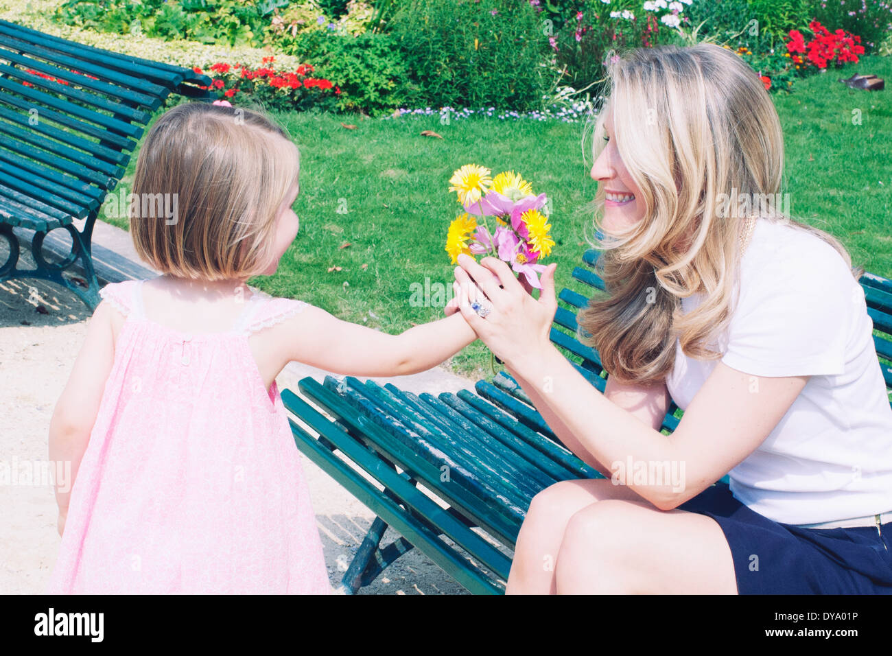 Little girl presenting mother with flower bouquet Stock Photo - Alamy