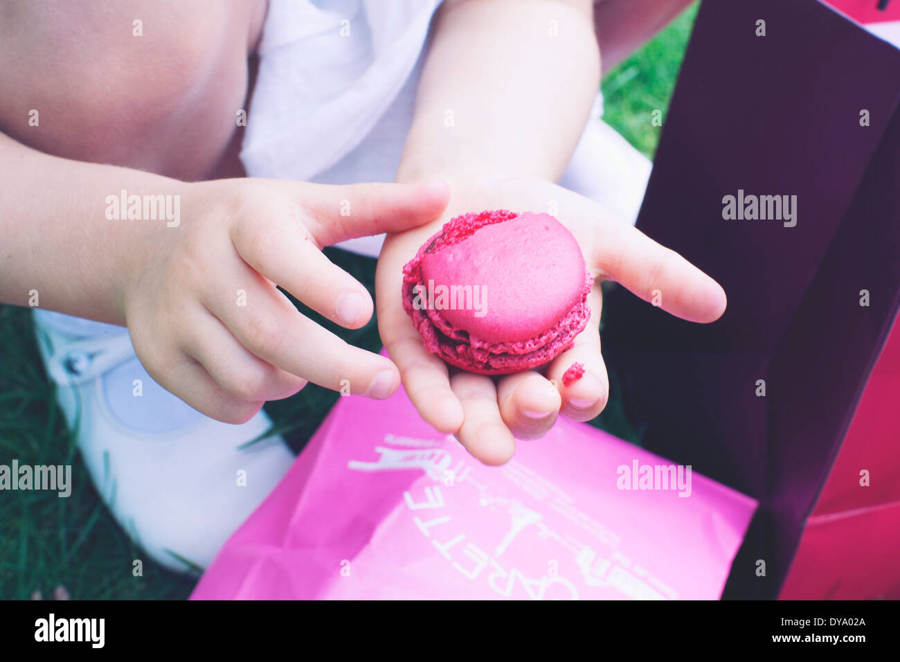 Child eating macaroon Stock Photo - Alamy