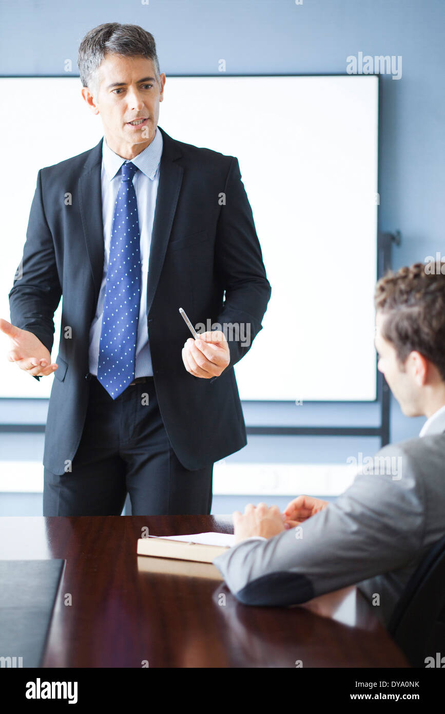 Business executive giving presentation at meeting Stock Photo - Alamy