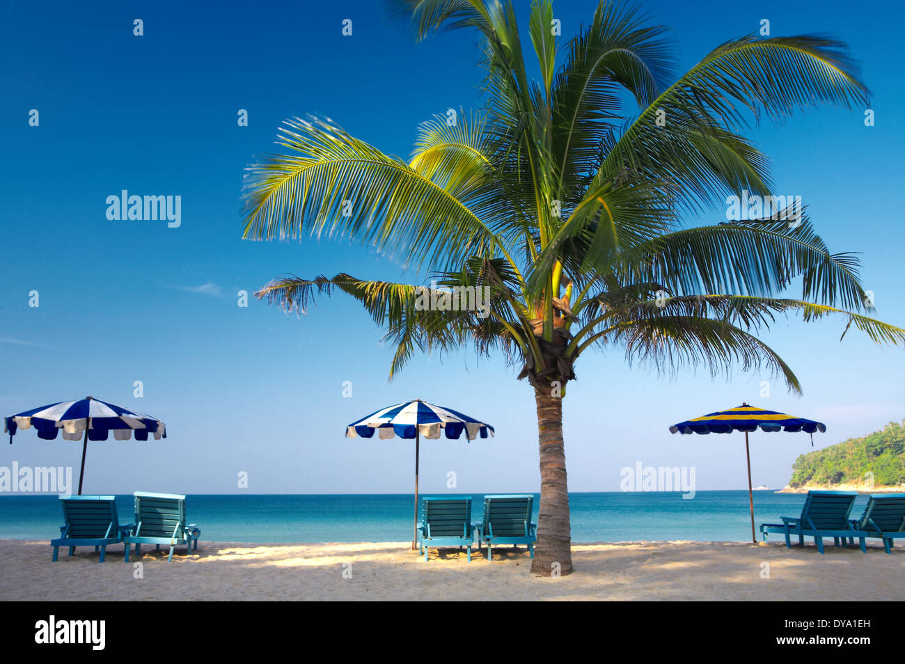 view of three chairs and umbrellas on the beach Stock Photo - Alamy