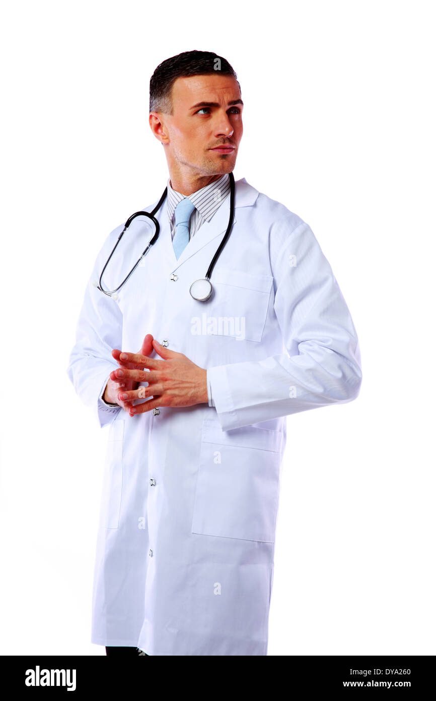 Pensive male doctor standing over white background Stock Photo - Alamy