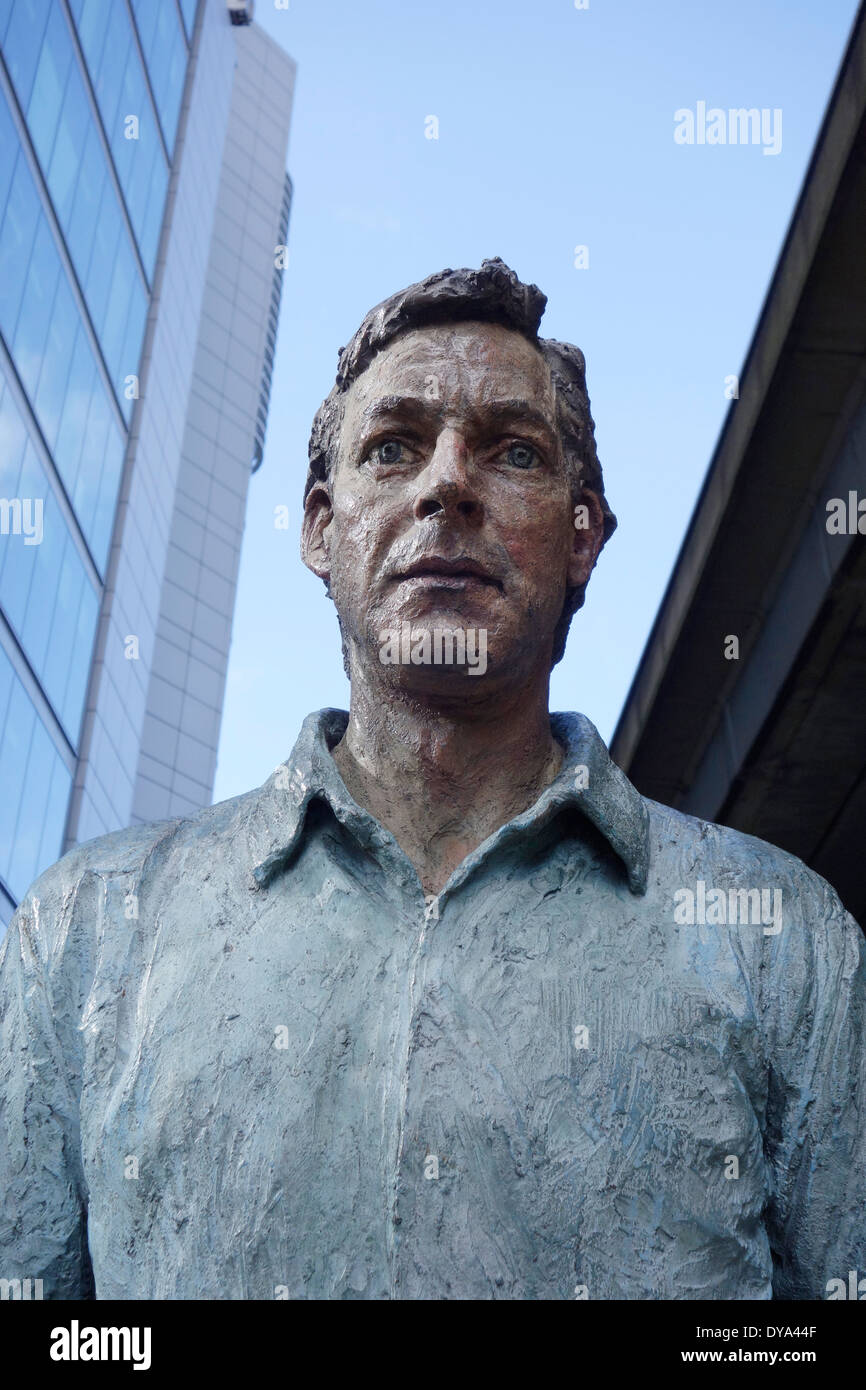 London, Paddington Basin. "Walking man", painted bronze statue by ...