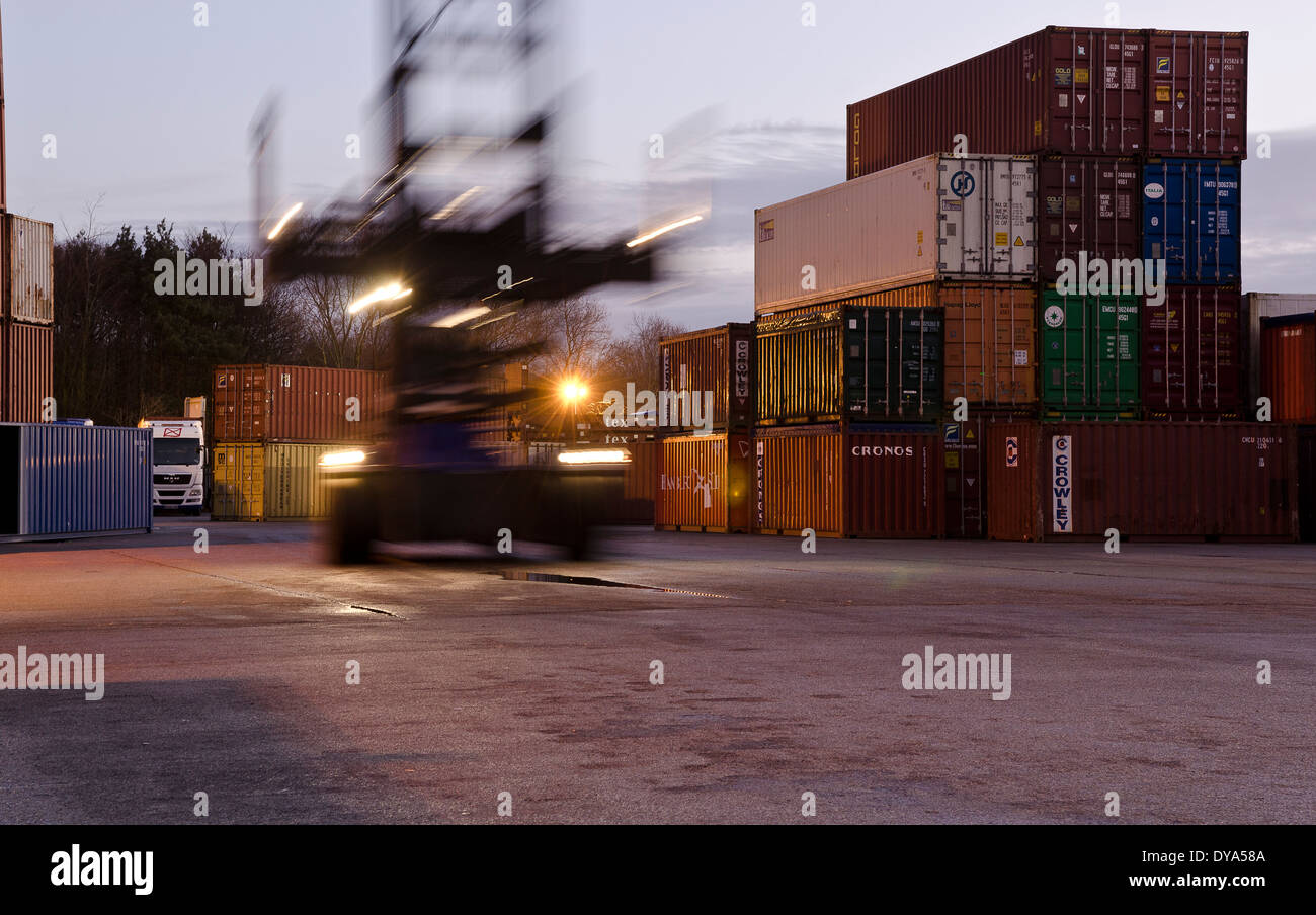 container stacker vehicle moving towards the camera, long exposure ...