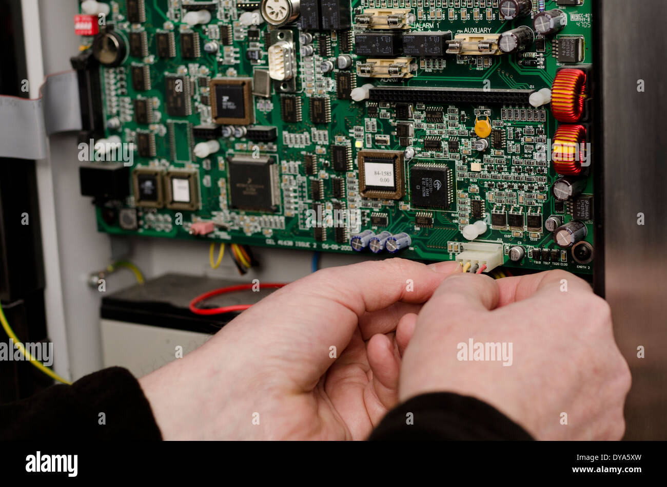 Two hands on circuit board hi-res stock photography and images - Alamy